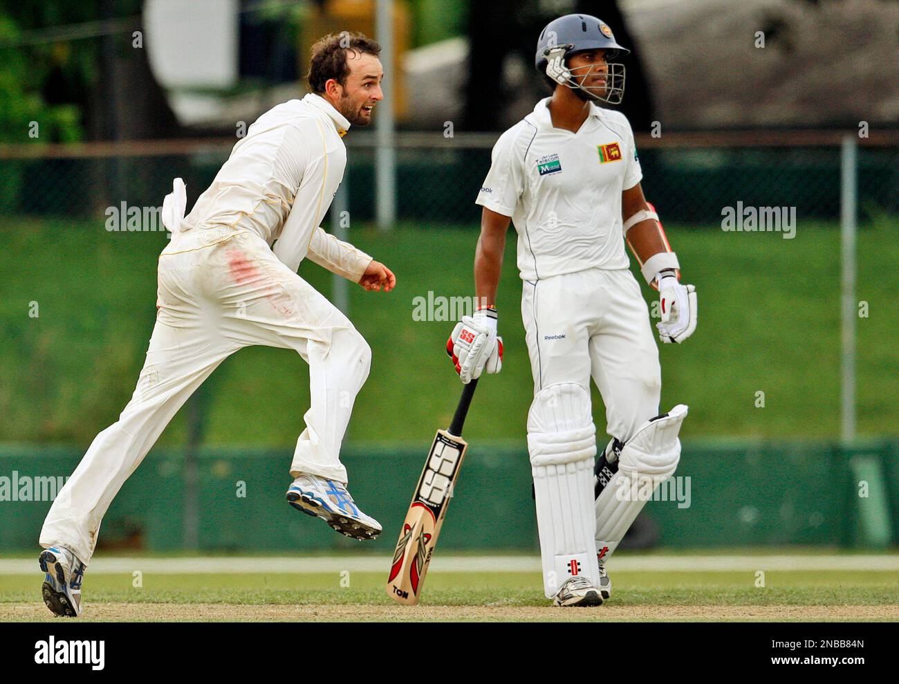 Australian cricketer Nathan Lyon bowls as Sri Lanka's Dinesh Chandimal ...