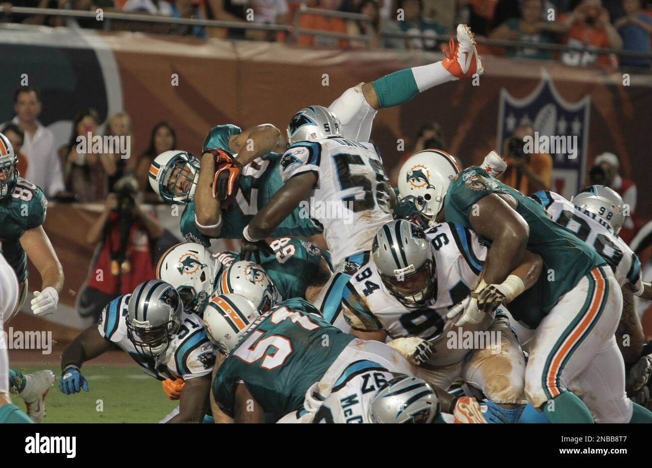 Miami Dolphins' Lex Hilliard (26) goes over the top of the line to ...