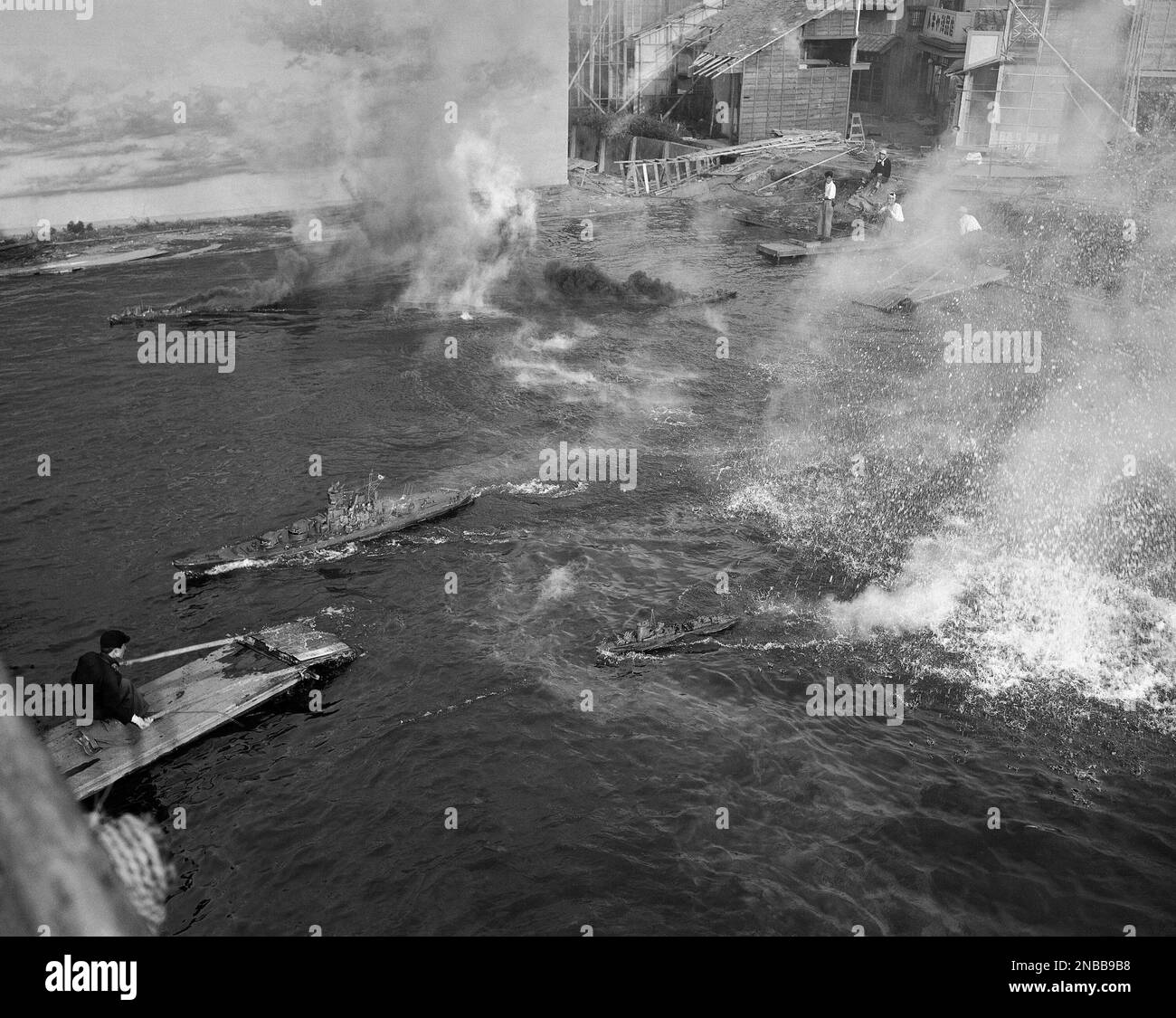 Shells from scale-model warships burst in a battle scene in the studio ...