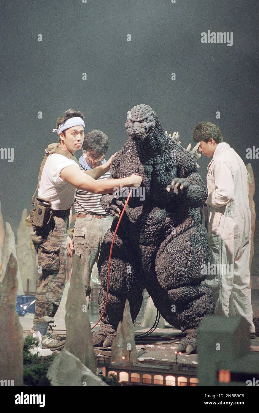 Staff members and propmen prepare Godzilla during the filming of the ...