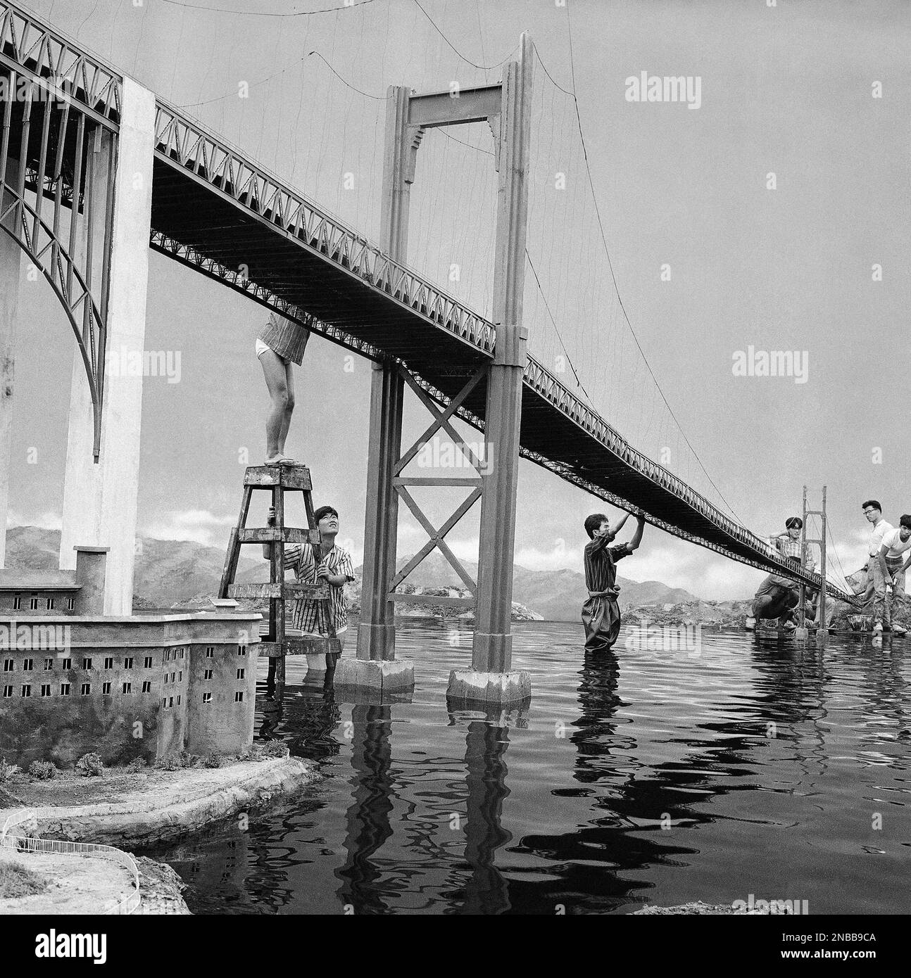 Workmen build a model of San Francisco’s Golden Gate Bridge for use in ...