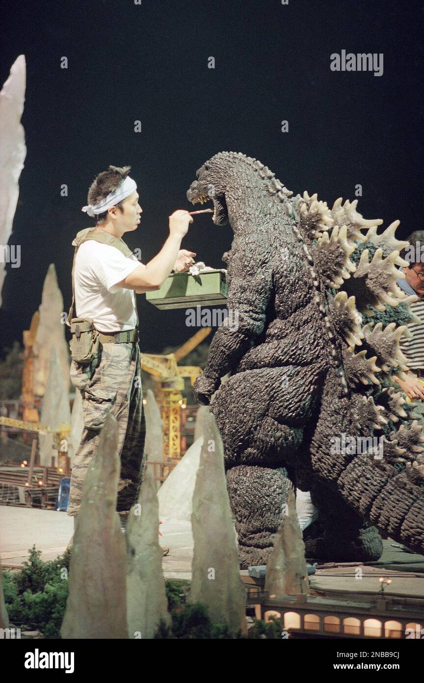 Godzilla has its teeth painted during a break of filming of its latest ...