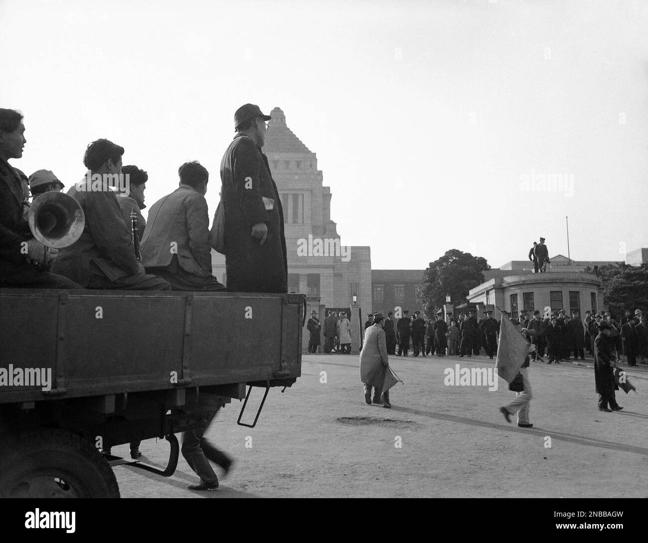 Japanese police watch the main gate of the Diet building as the crowd ...