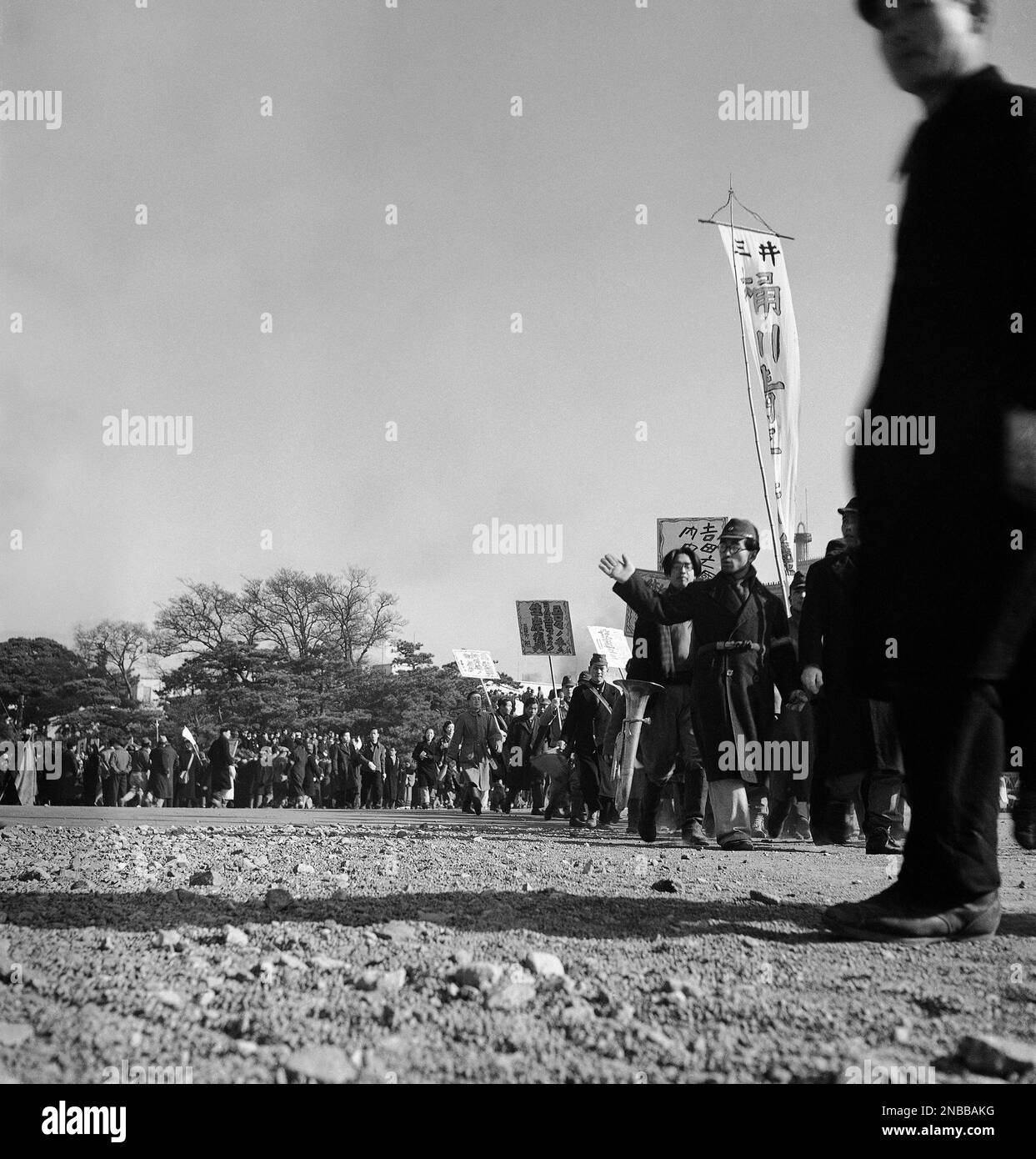 Walking holding placard western script protest Black and White Stock ...