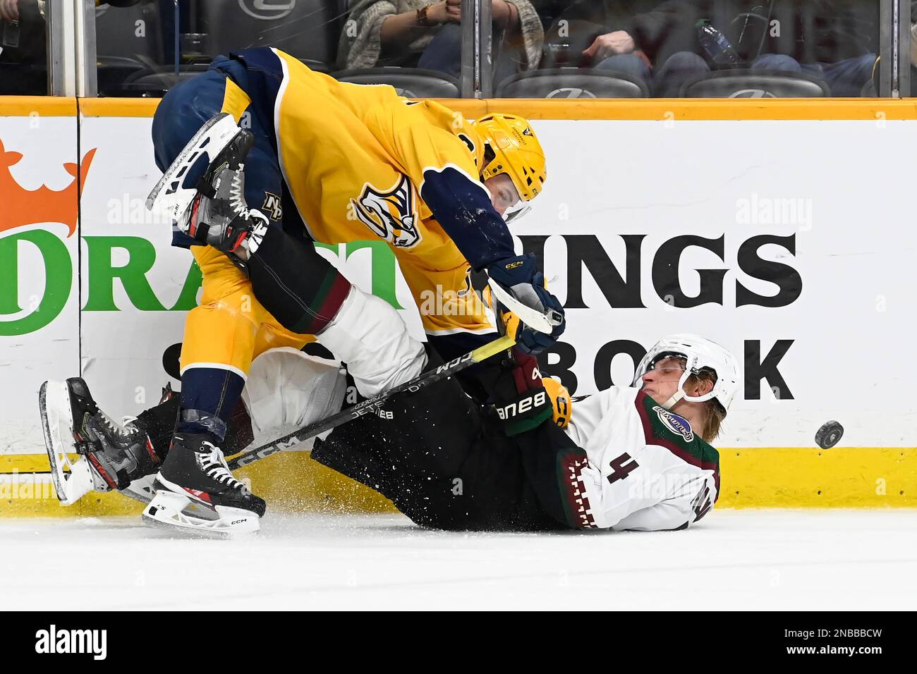 Nashville Predators left wing Cole Smith, left, checks Arizona Coyotes ...