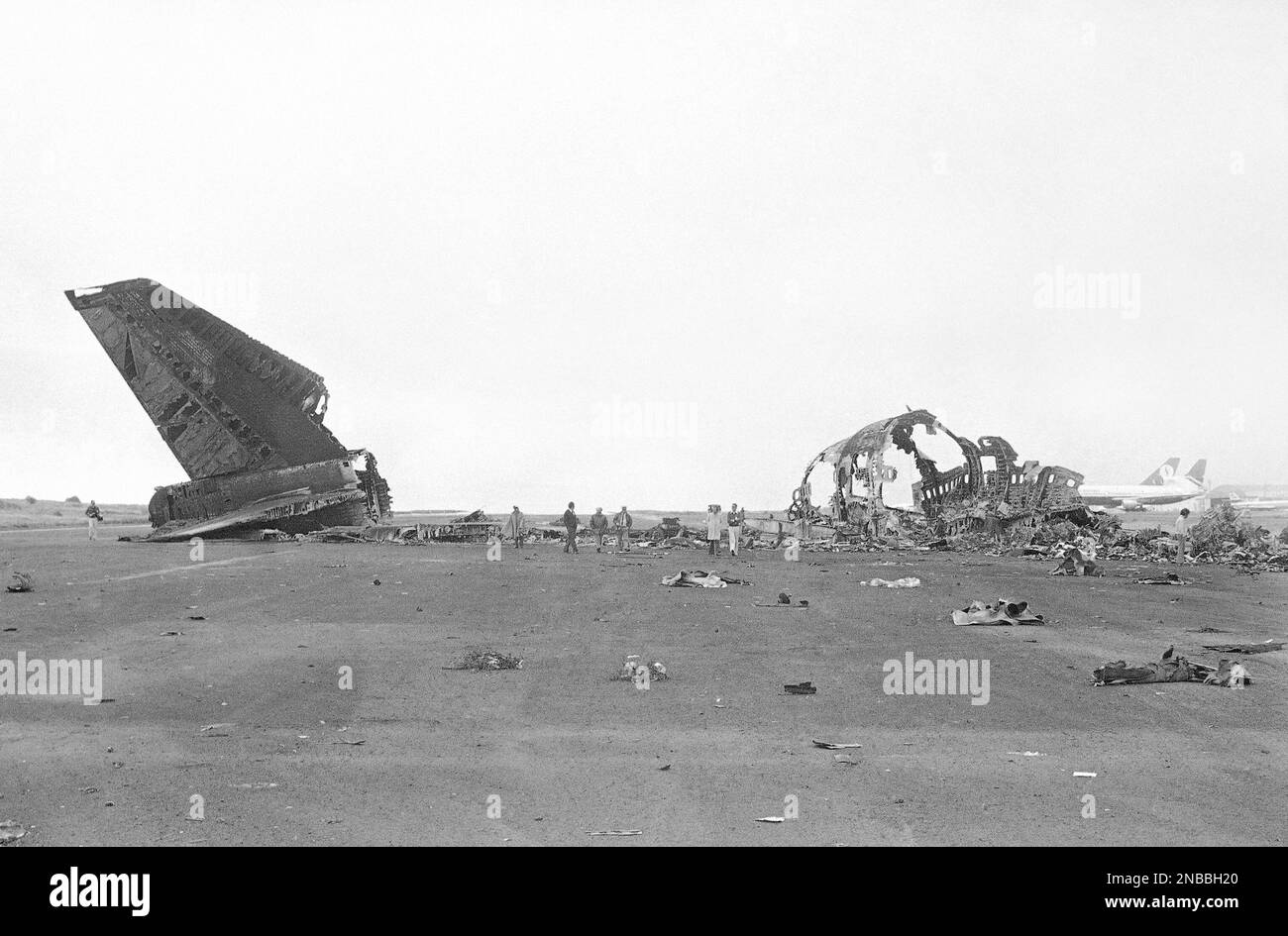 The burnt out tail section of the KLM jumbo jet lies on runway at Los ...