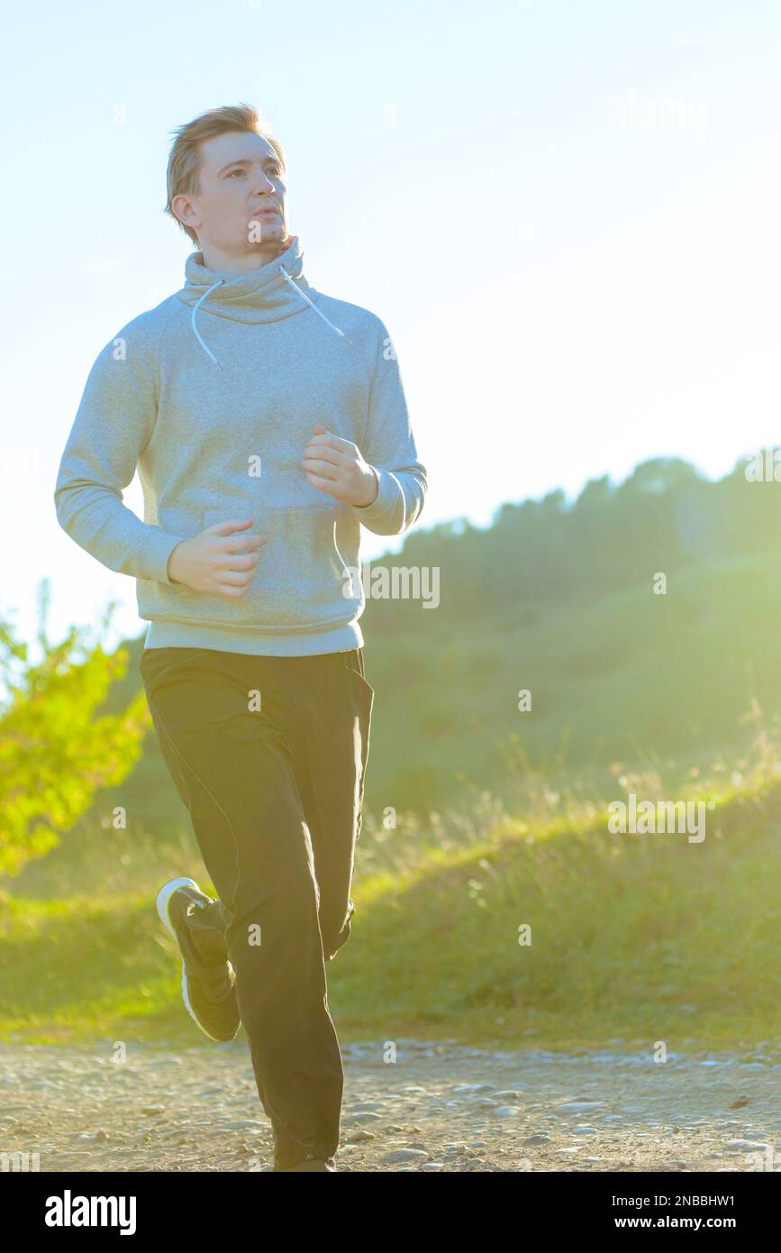 Running man jogging in rural nature at beautiful summer day. Sport ...