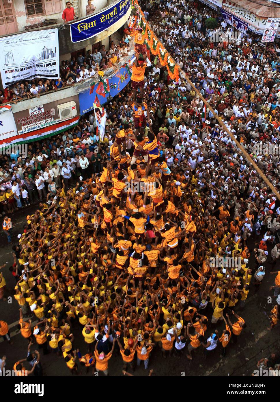 Indian youth make a human pyramid to break the "Dahi Handi," an earthen ...