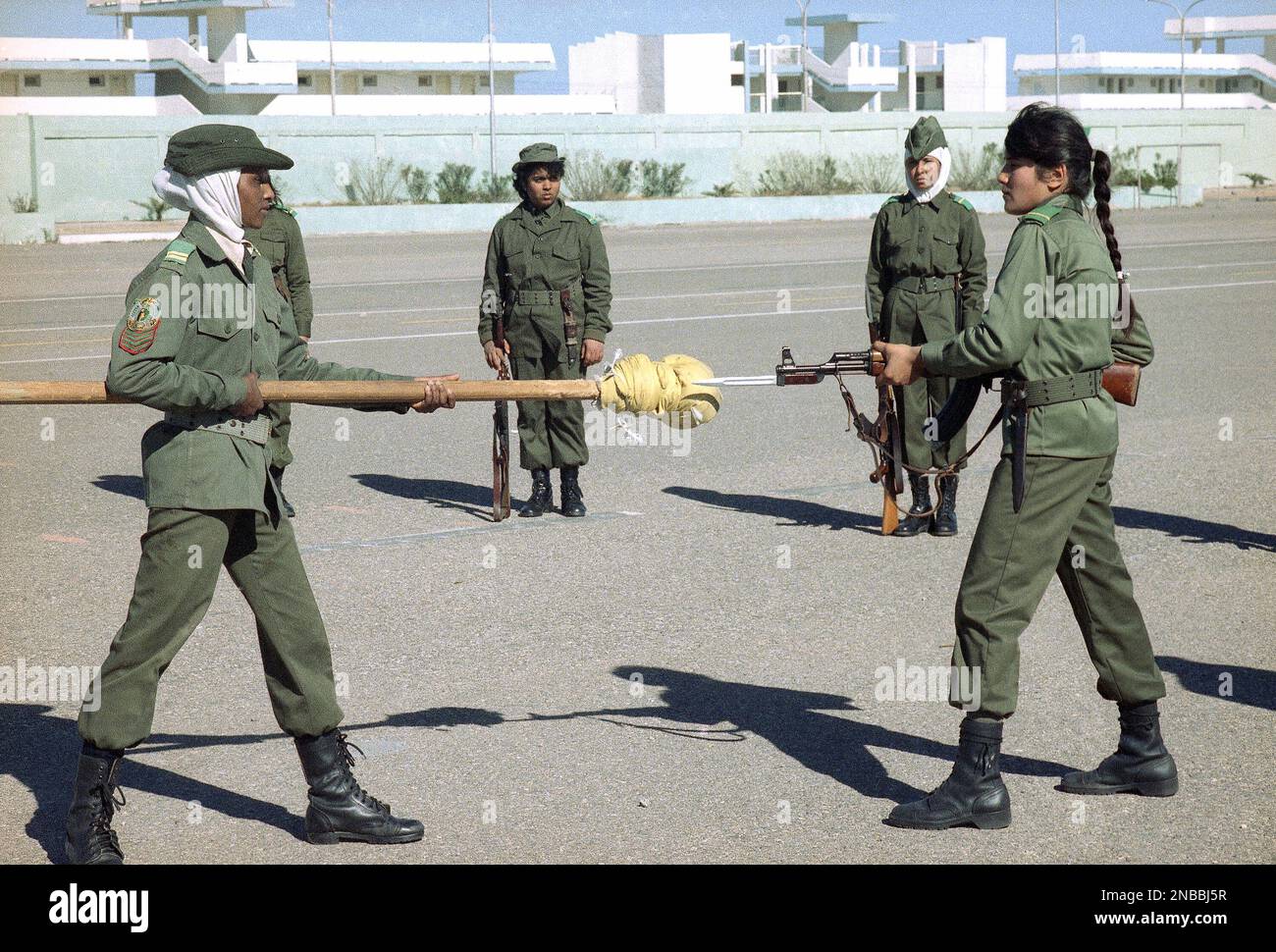 A female Libyan soldier and her instructor face each other during a ...