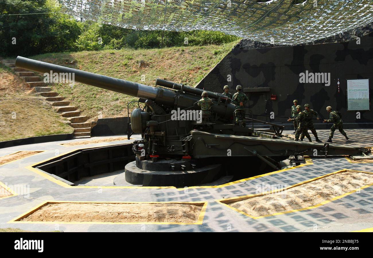 Taiwanese military soldiers load a 240 mm Howitzer gun during an ...