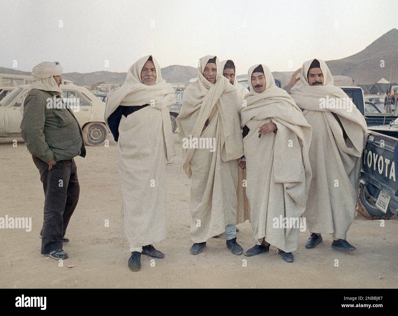 A group of locals stand in a group near the Libyan factory complex in ...