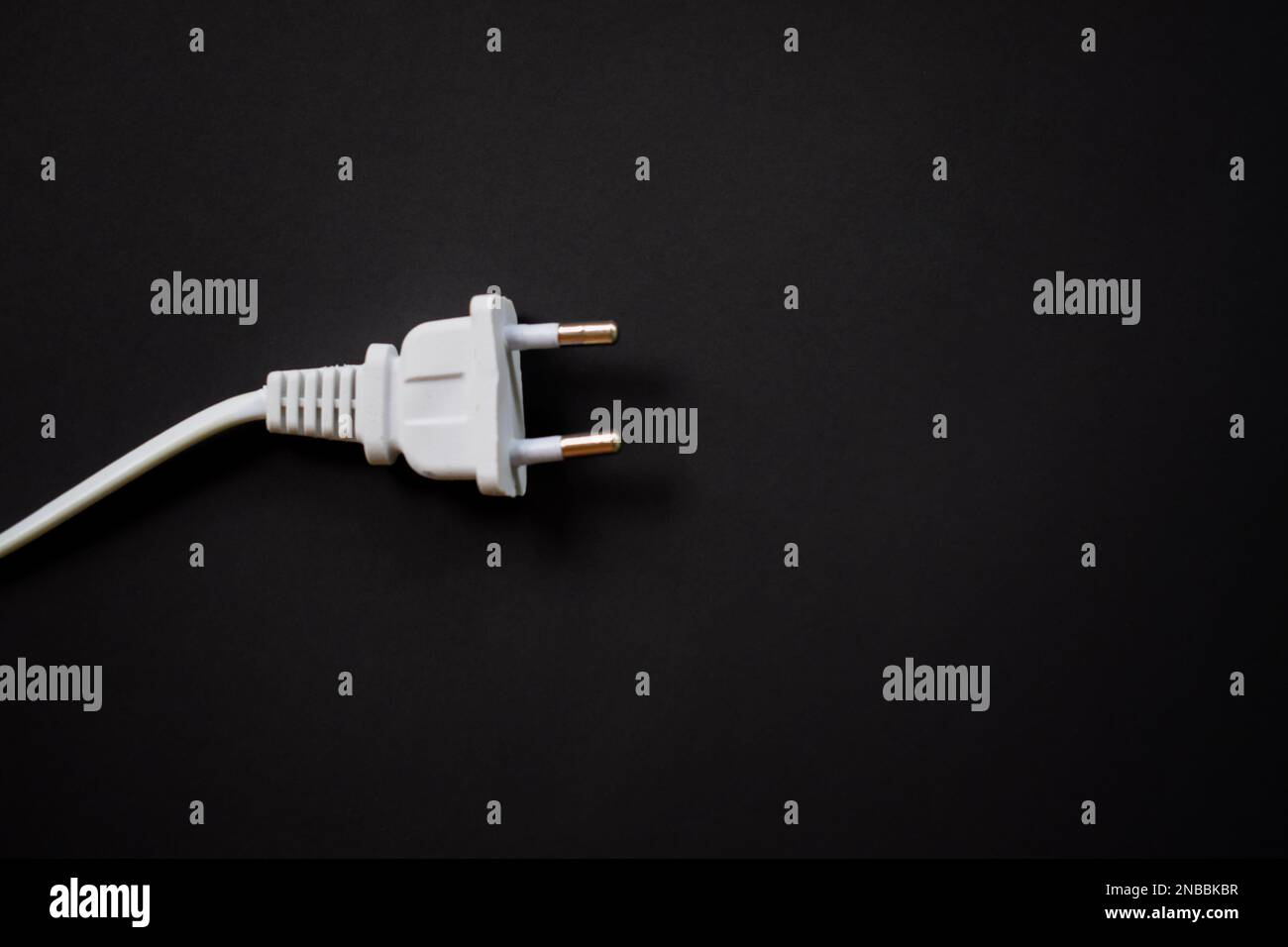 Electric European plug isolated on black background. White power cable ...