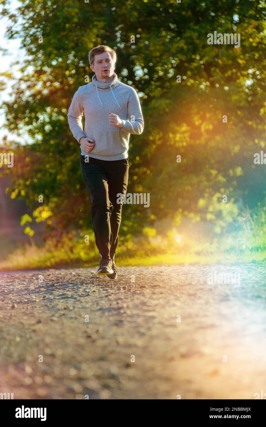 Running man jogging in rural nature at beautiful summer day. Sport ...