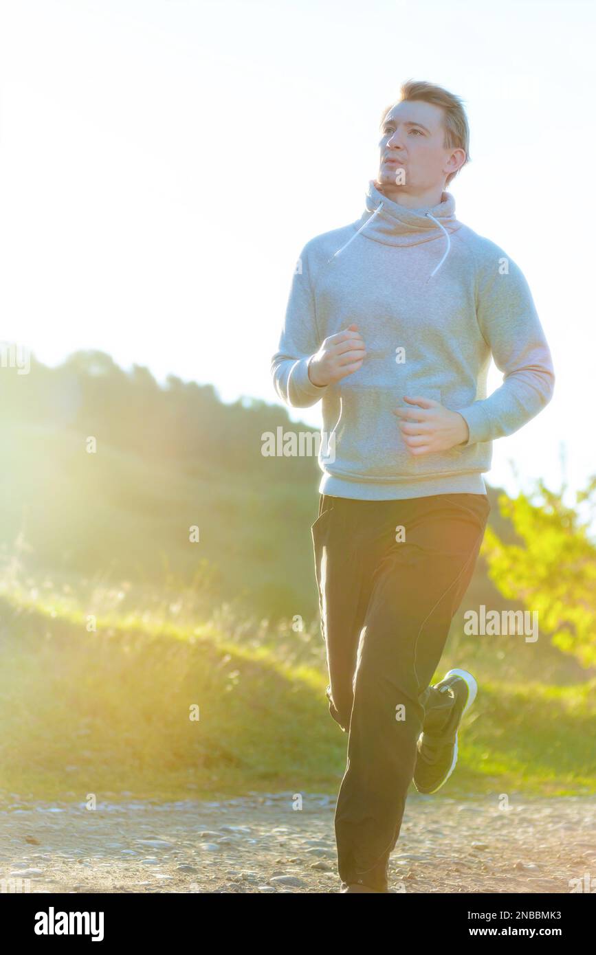 Running man jogging in rural nature at beautiful summer day. Sport ...