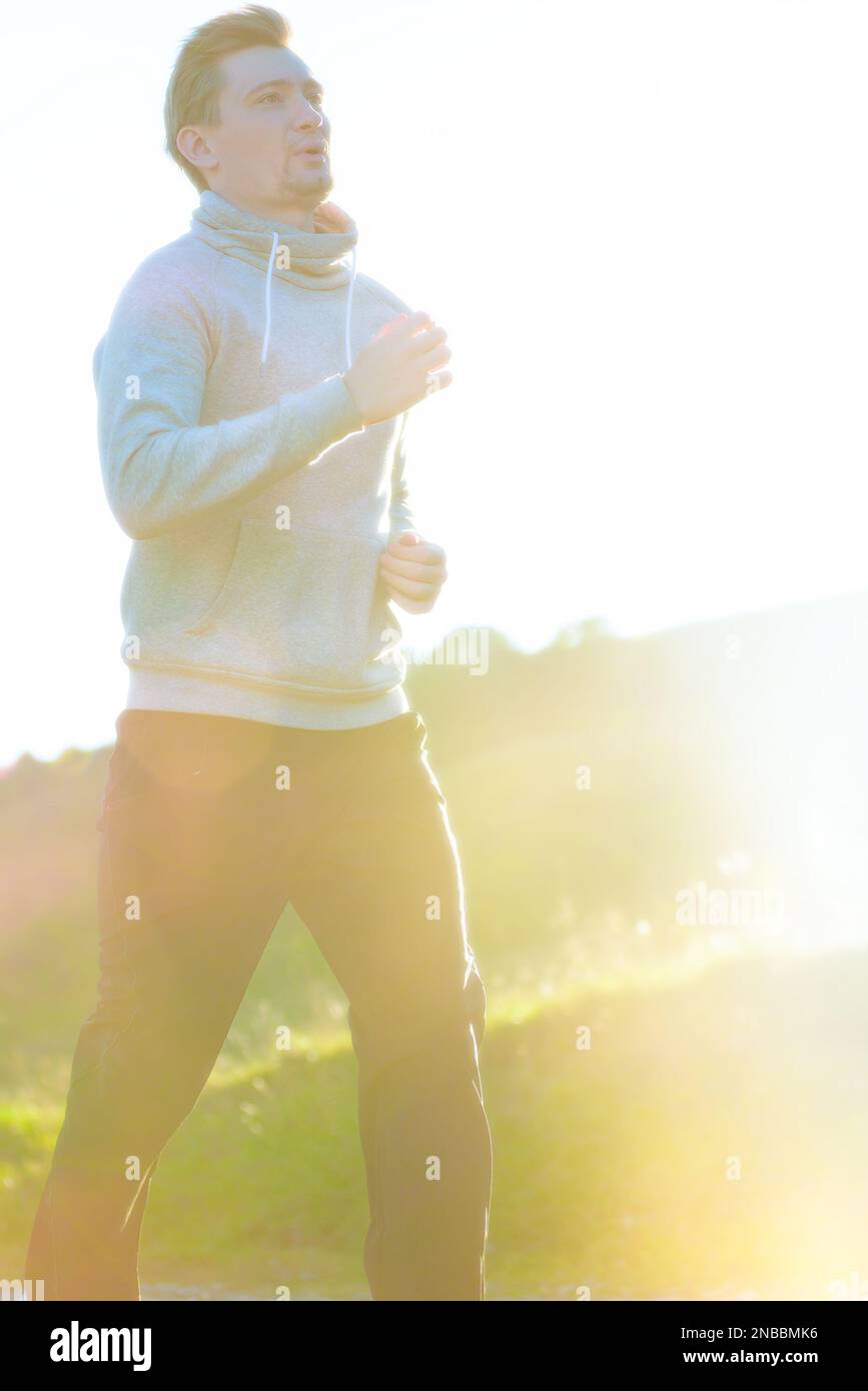 Running man jogging in rural nature at beautiful summer day. Sport ...