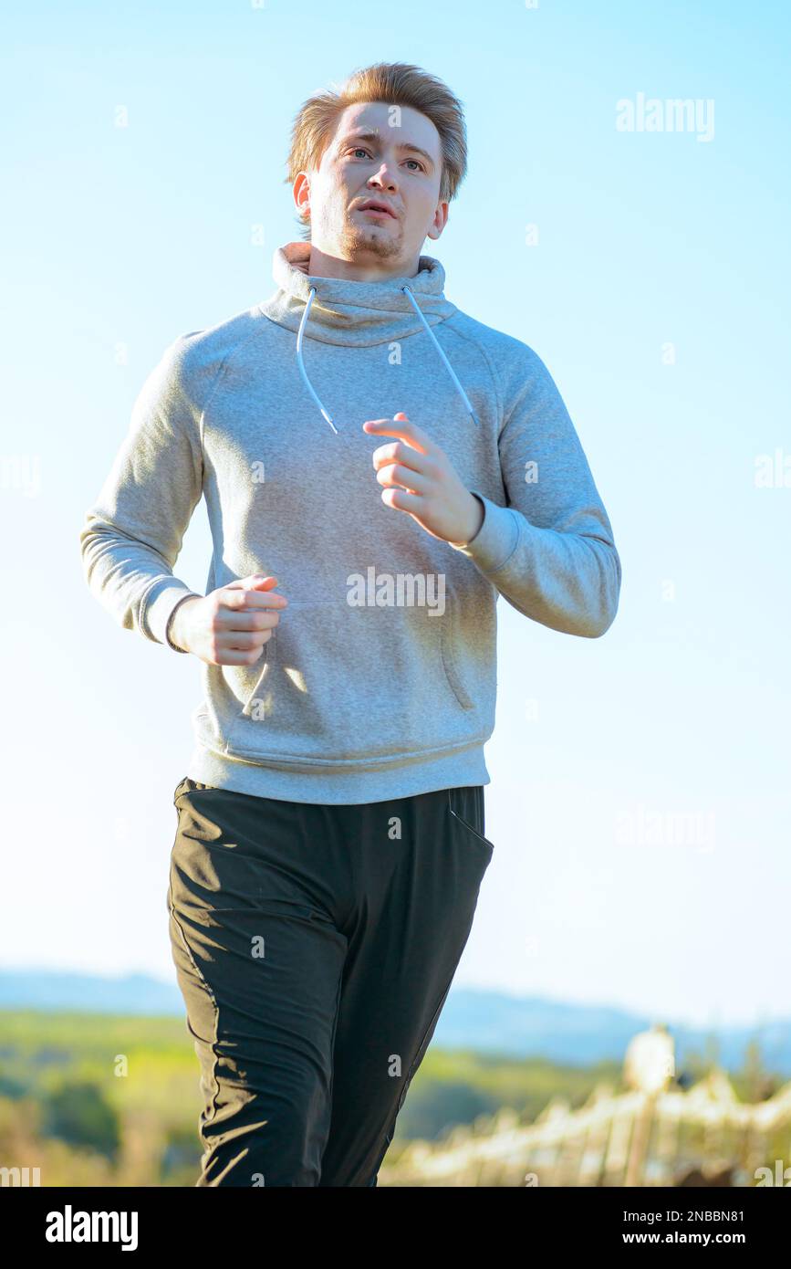 Running man jogging in rural nature at beautiful summer day. Sport ...