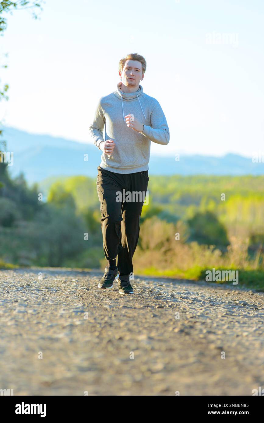 Running man jogging in rural nature at beautiful summer day. Sport ...