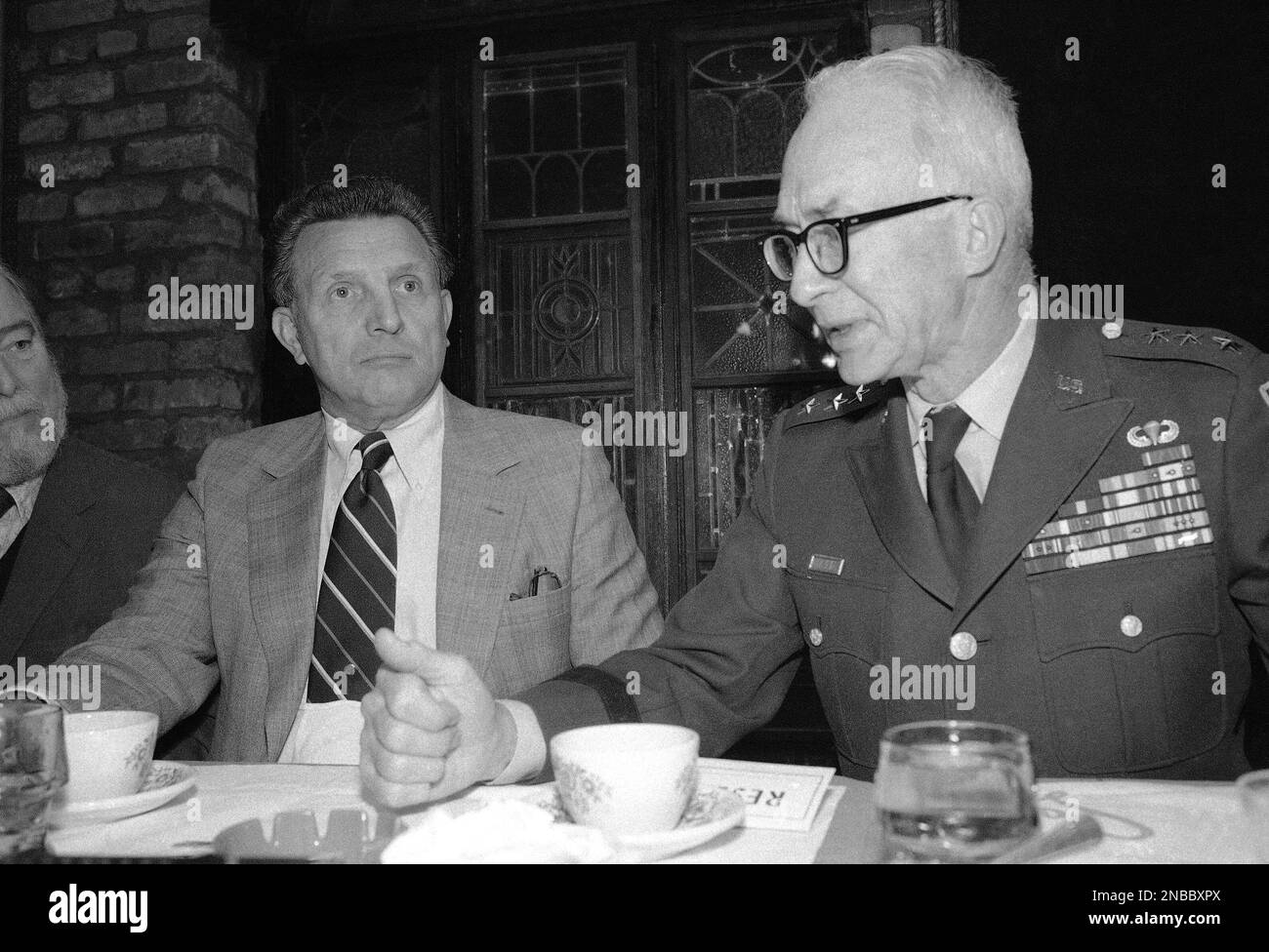 New Army head football coach Lou Saban, left, sits next to ...