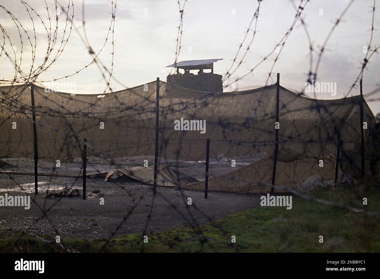 barbed wire and a manned guard tower outside Maze Prison, also known as ...