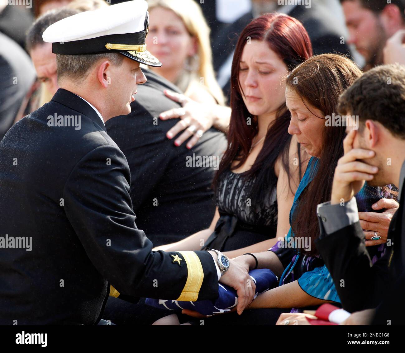 Rear Admiral William E. Leigher, left, presents a flag to Elizabeth ...