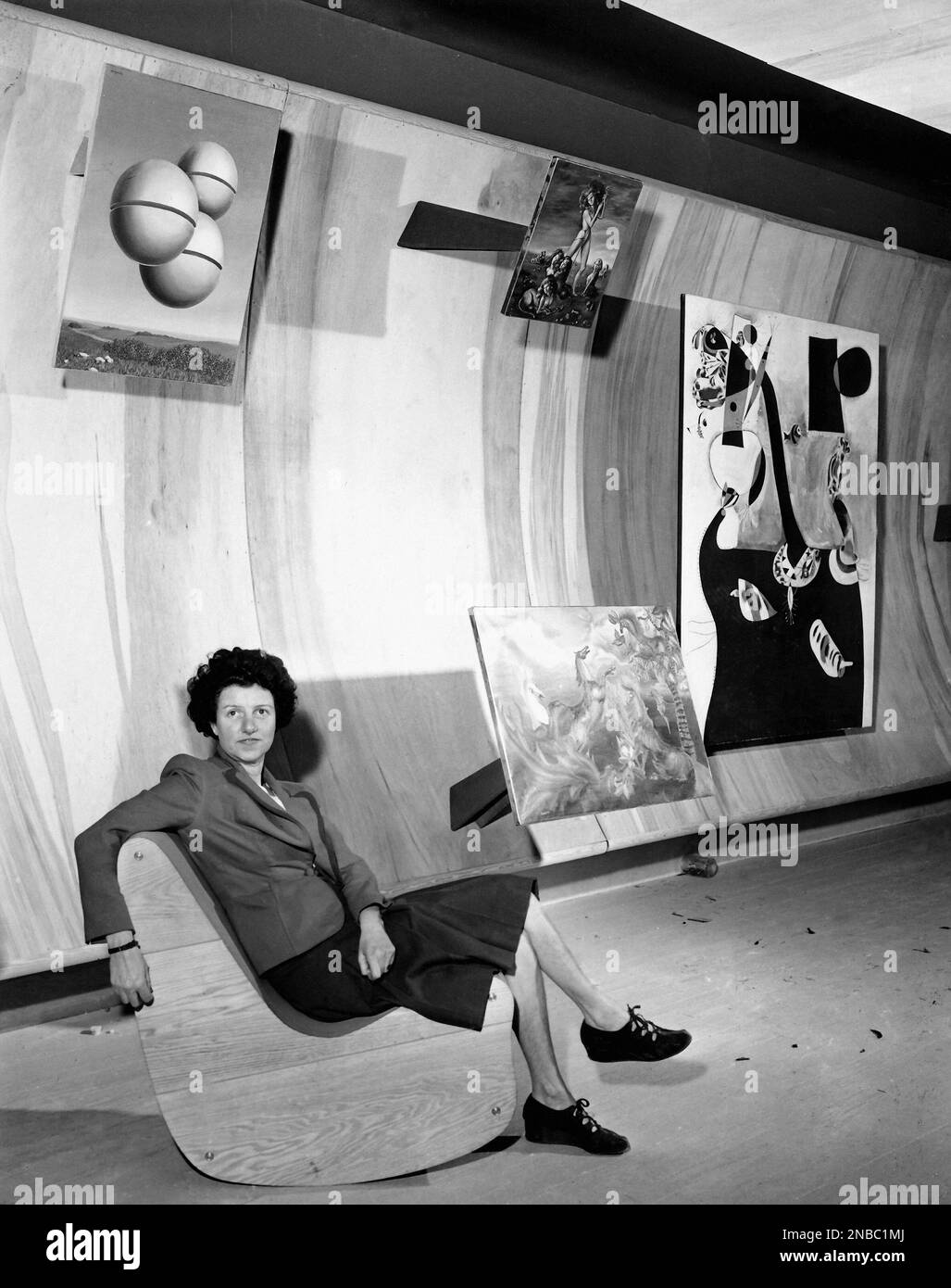 Art collector Peggy Guggenheim poses with paintings at her Art of this Century gallery in New ...