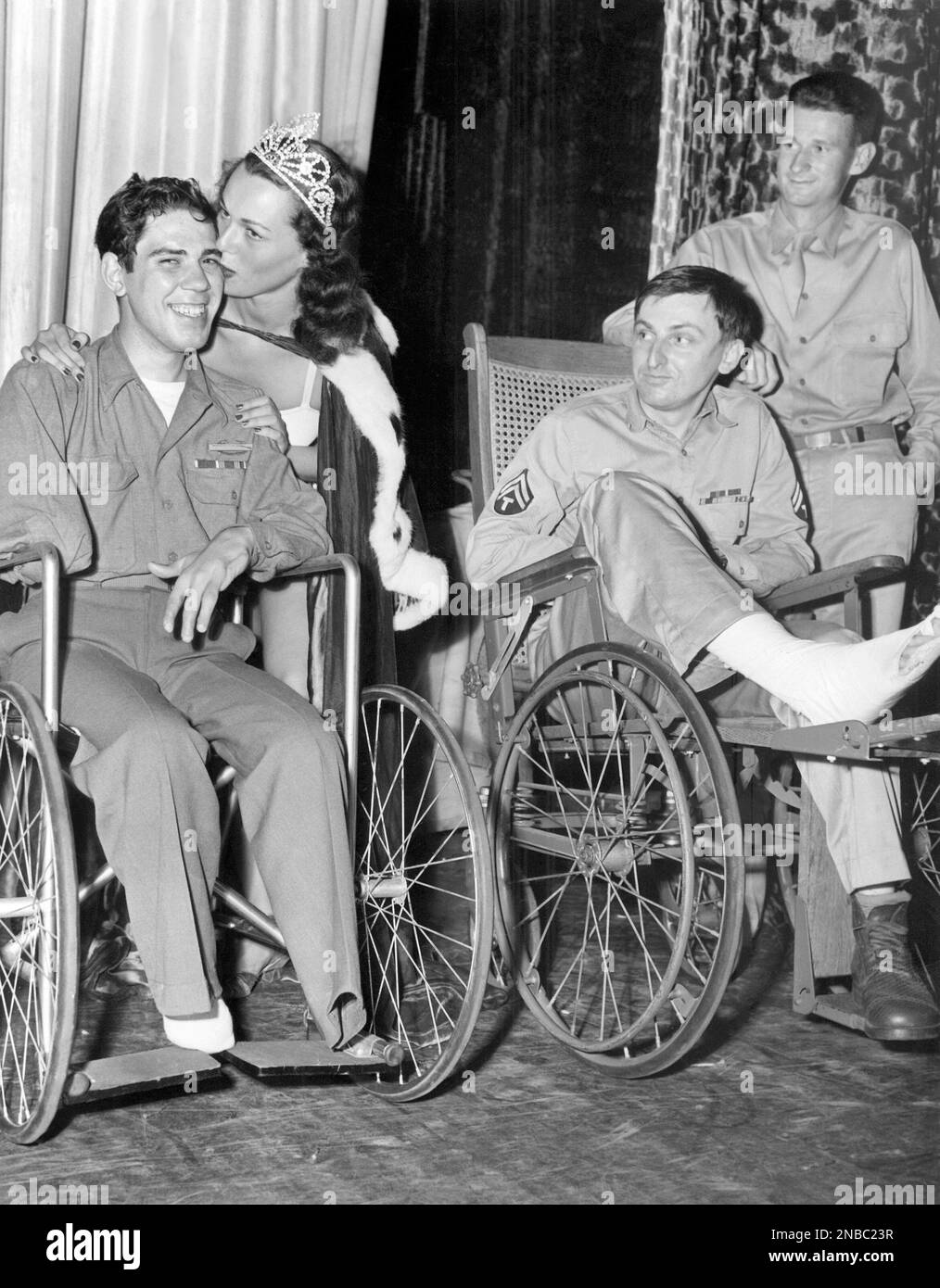 Ernie Sardo, left, of Elmira, N.Y. is kissed by Bess Myerson, Miss New York City after she won ...