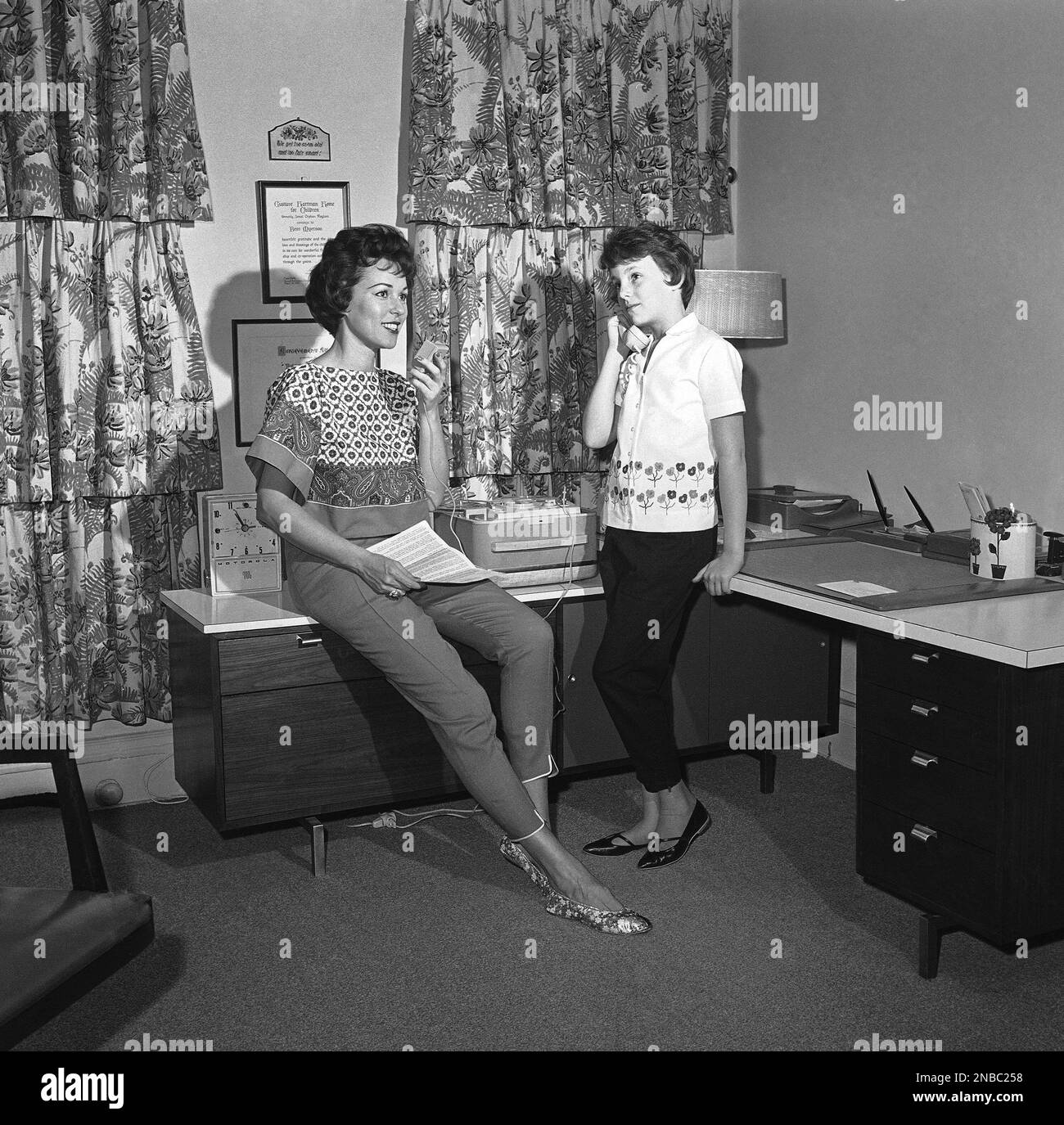 Working at a tape recorder in connection with her TV program, Bess ...