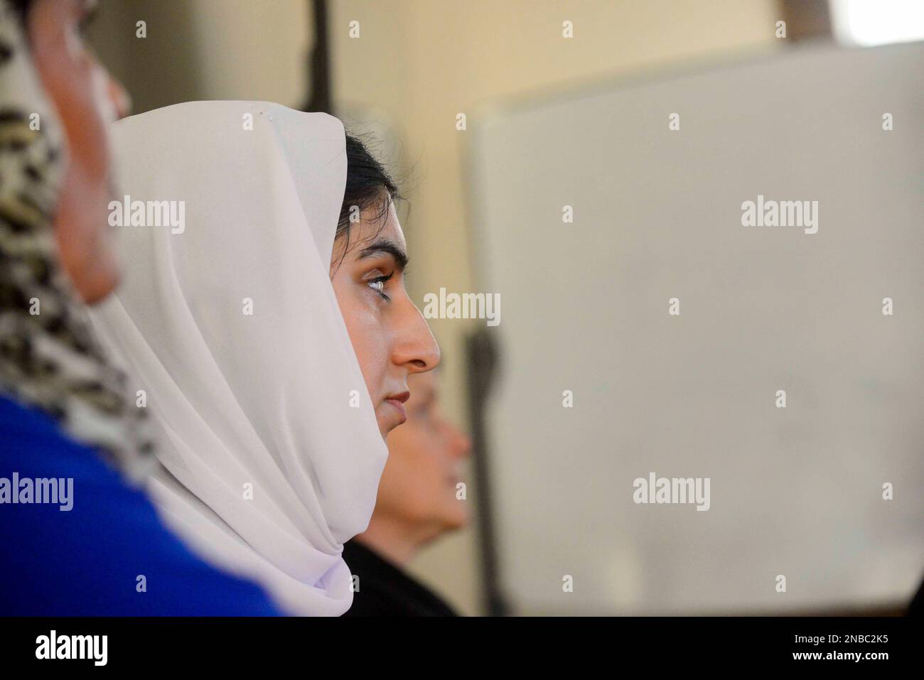 Nada Amiri, an Afghan refugee, listens to Rep. Becca Balint, D-Vt., at ...