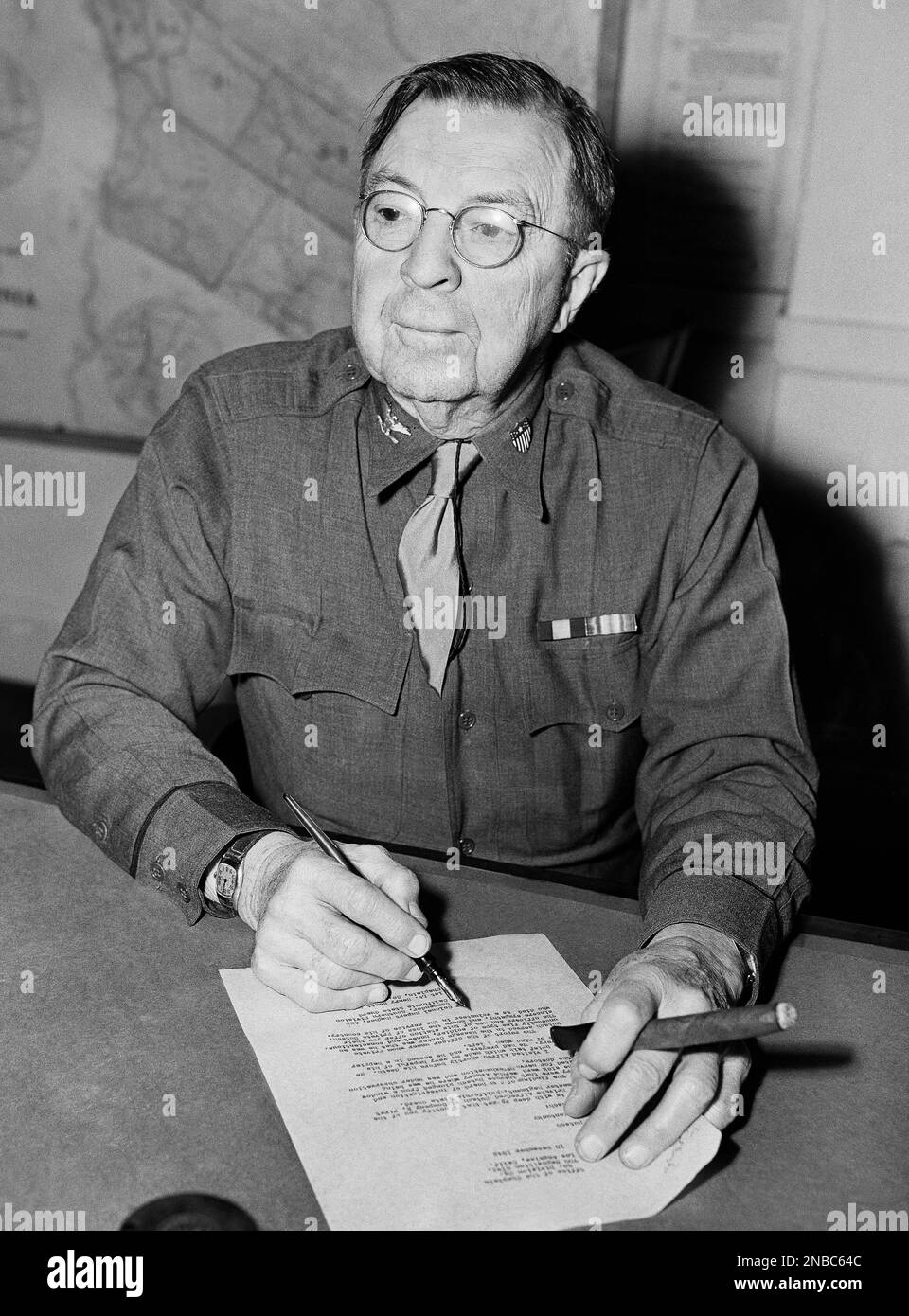 Colonel Rupert Hughes of the California State Guard smokes a cigar in ...