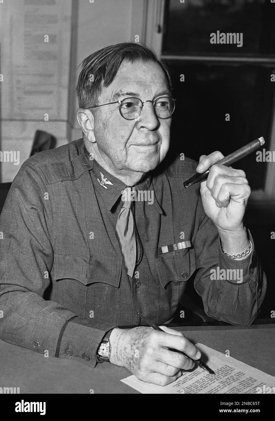 Colonel Rupert Hughes of the California State Guard smokes a cigar in ...