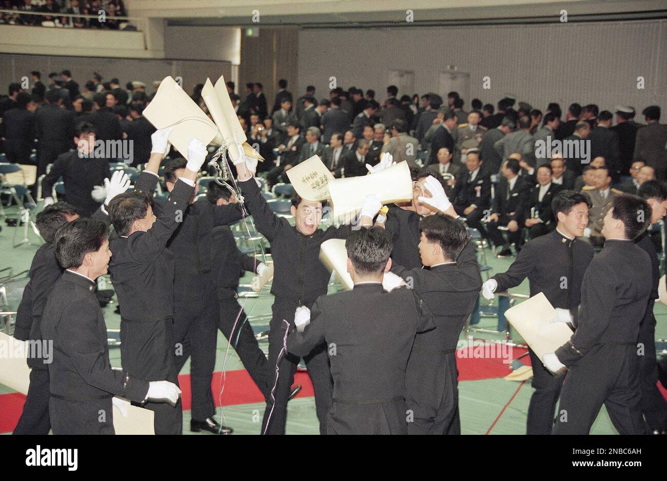 Defense Academy graduates hoist diplomas in joy during the commencement ...