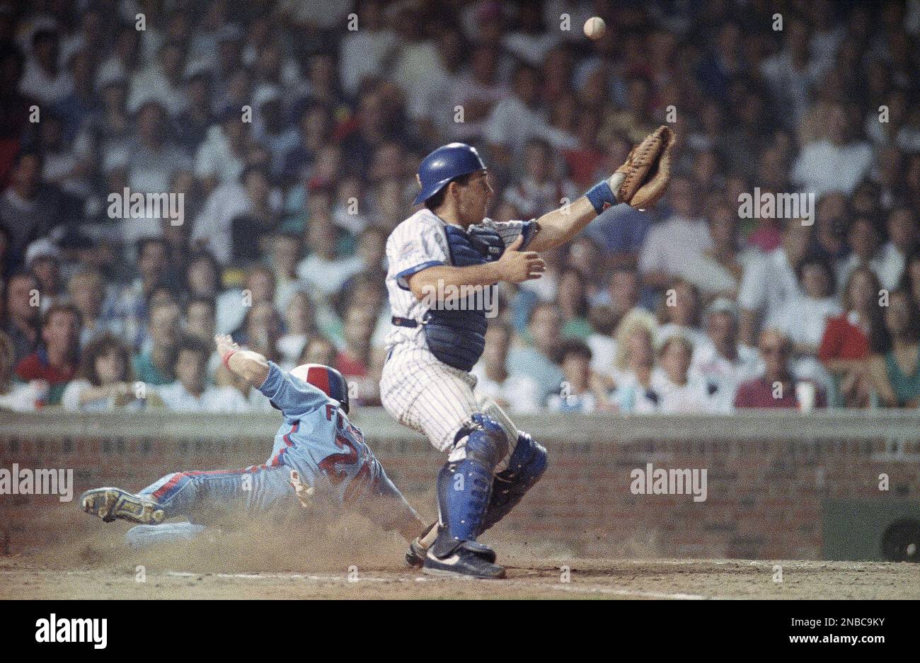 Chicago Cubs catcher Joe Girardi, right, reaches for a high throw as ...