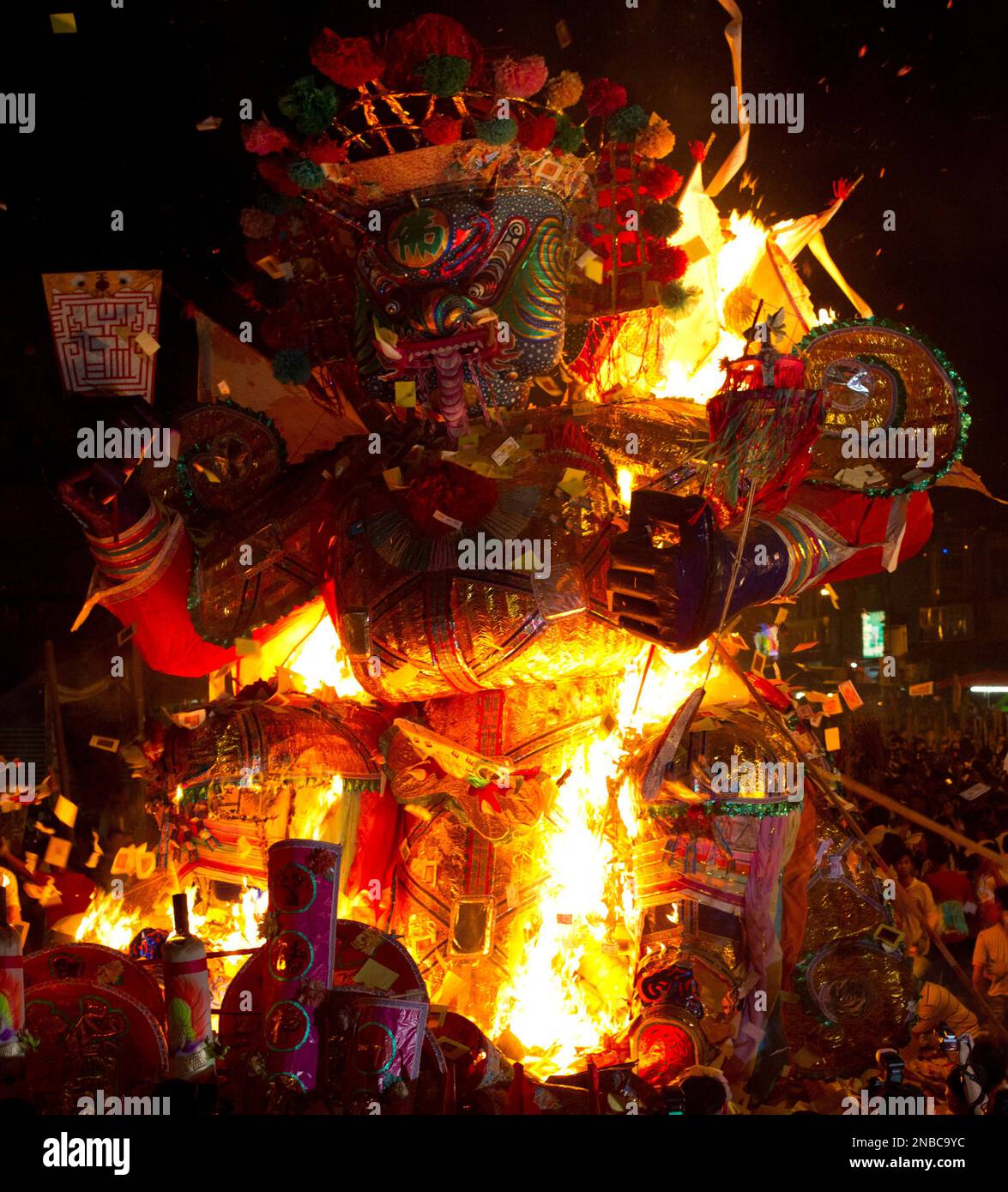 Malaysian Chinese perform prayers in front of the giant paper statue of ...