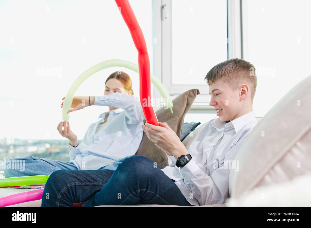 Children inflate modelling balloons. kids having fun with balloons ...