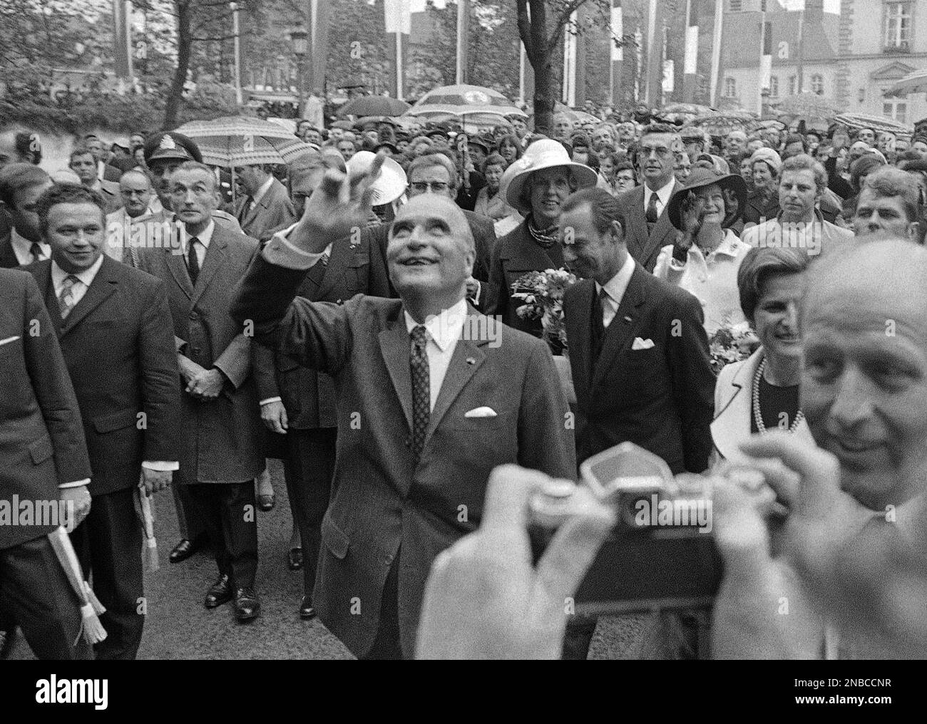 French President Georges Pompidou waves to well-wishers upon his ...