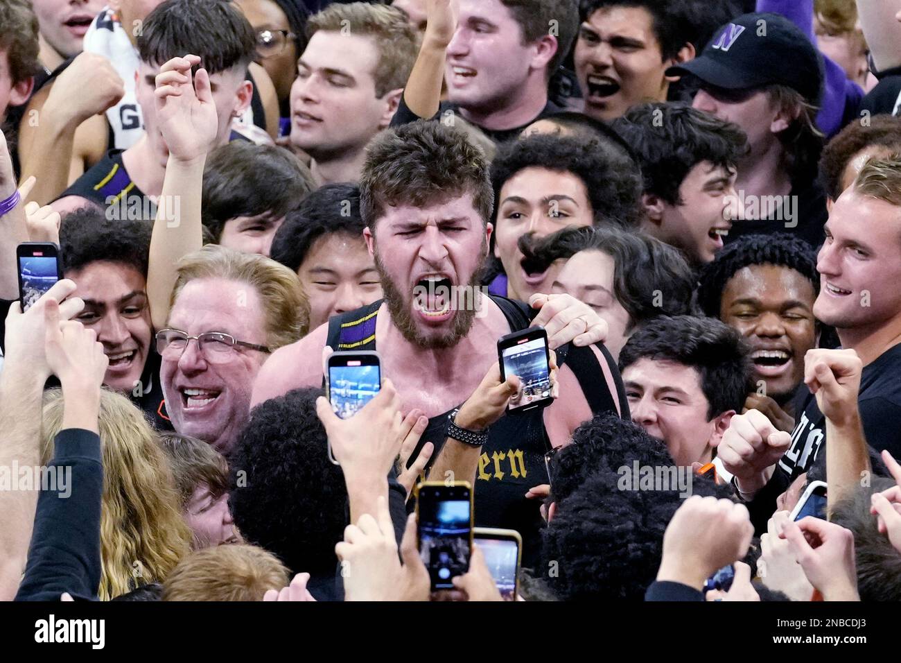 Northwestern center Matthew Nicholson, center, celebrates with fans ...