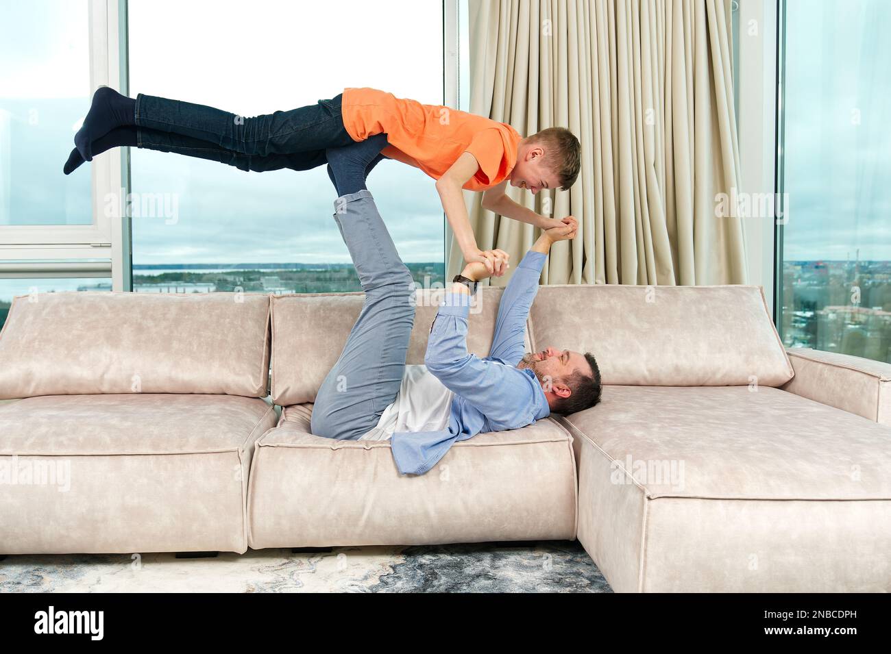 Father and son having fun at home. Parents spending quality time with ...