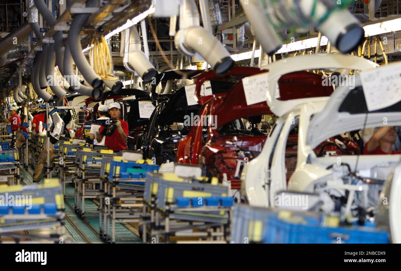 In this photo taken on July 2, 2011, Nissan Motor Co. employees work on ...