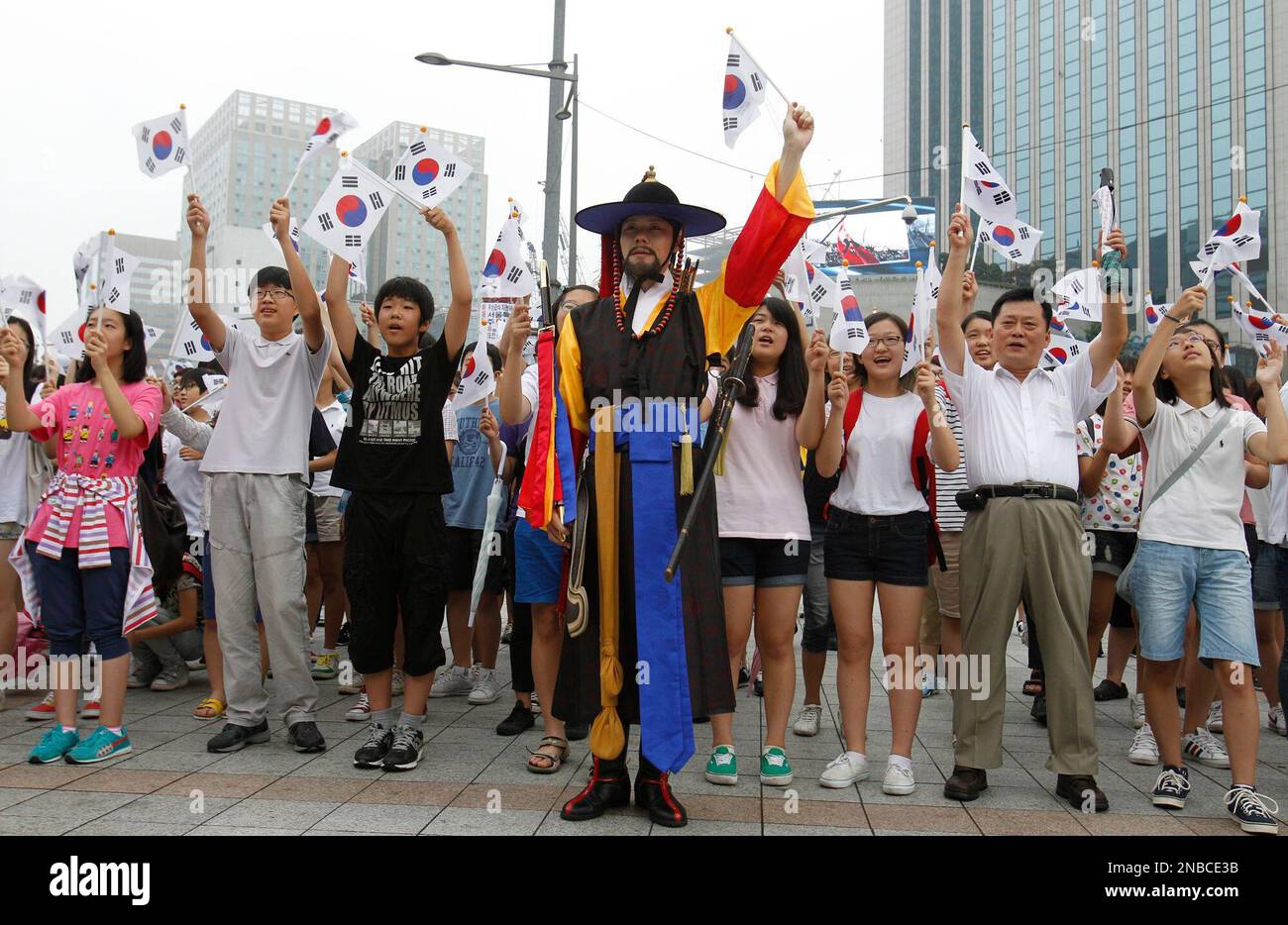 South Koreans wave their national flags to celebrate the Liberation Day ...