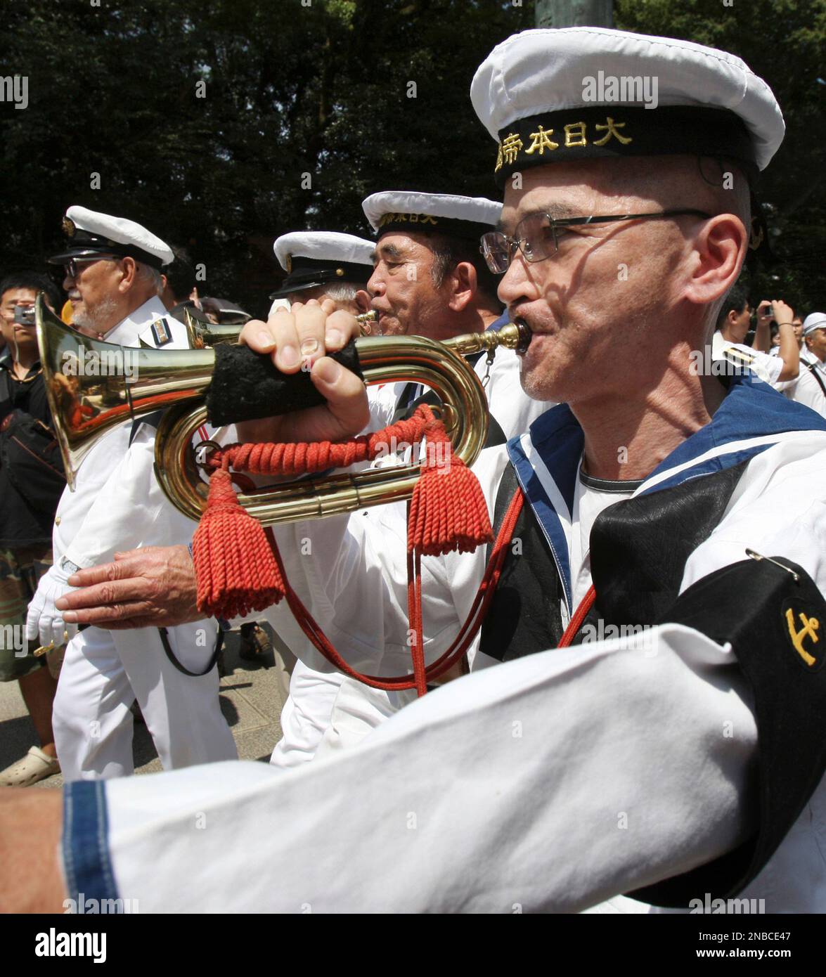 Men in Japanese Imperial Navy uniform sound the march through the gate ...
