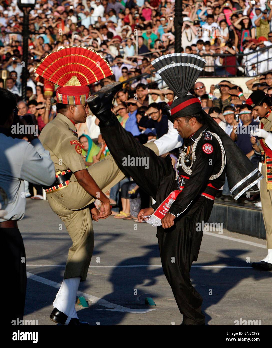 Pakistani Rangers soldier in black uniform and his Indian counterpart ...
