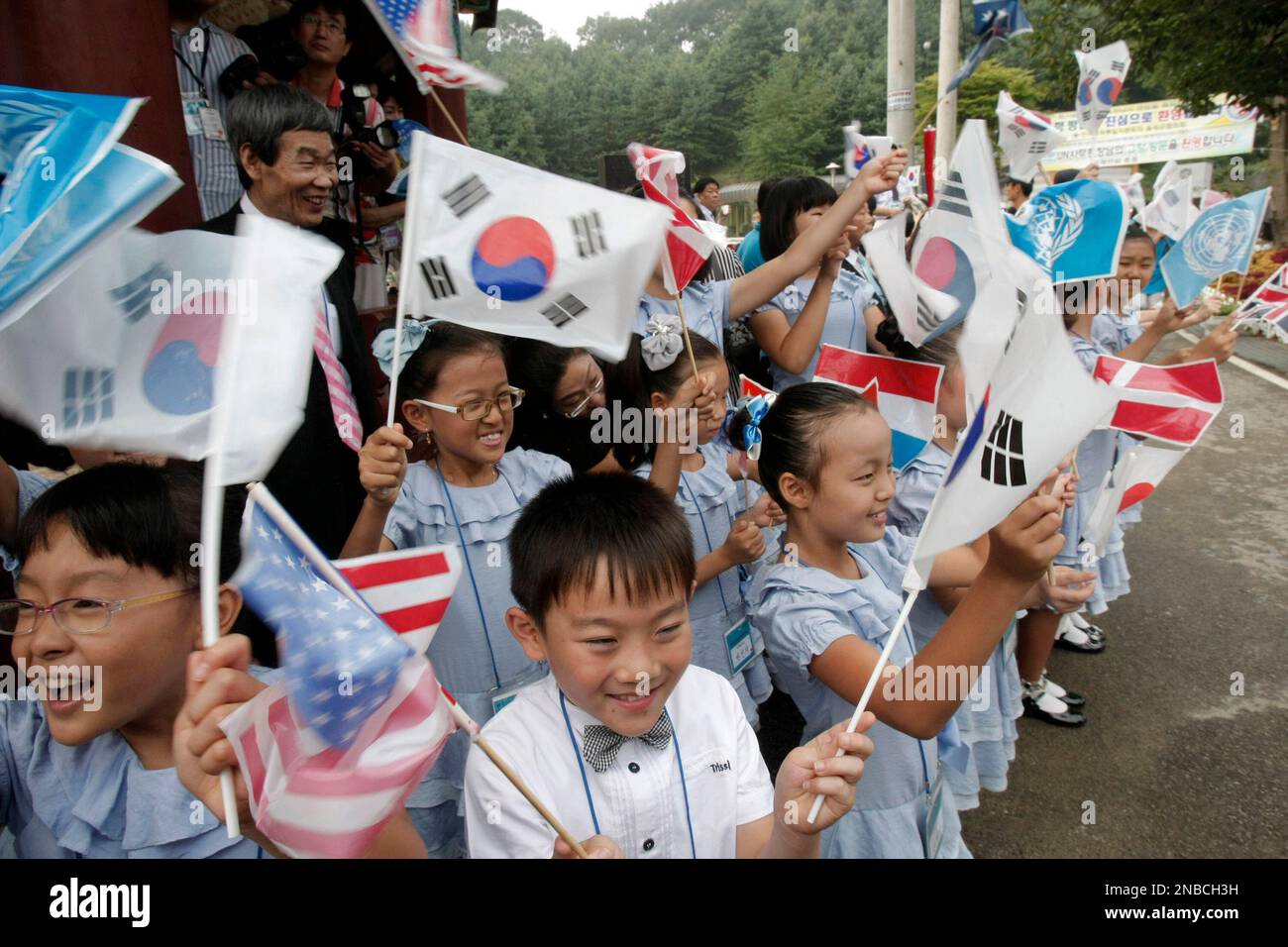 South Korean elementary school students wave flags of South Korea and ...