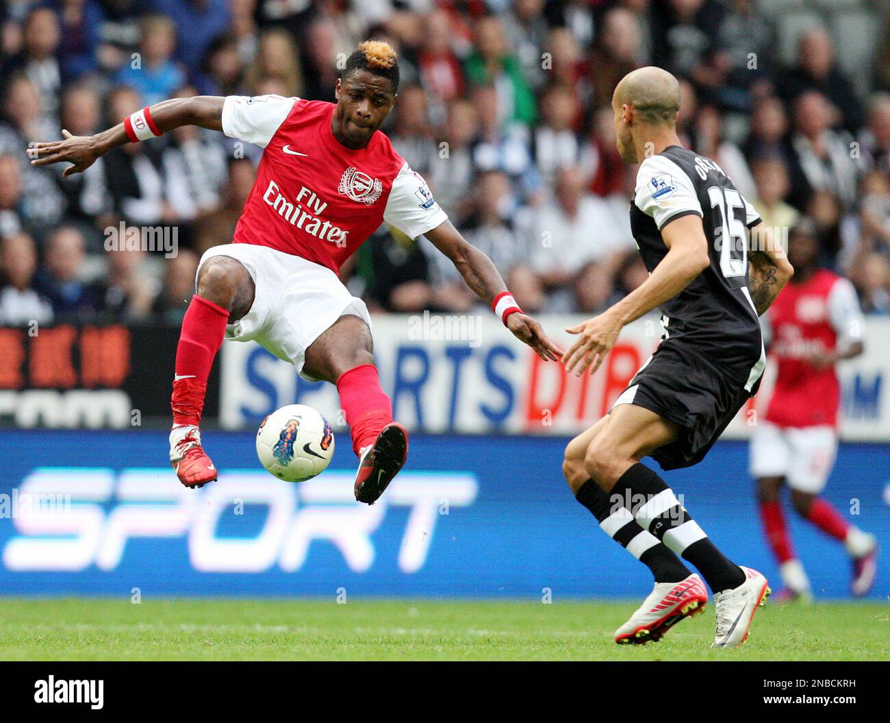 Arsenal's Alex Song, left, controls the ball from Newcastle United's ...