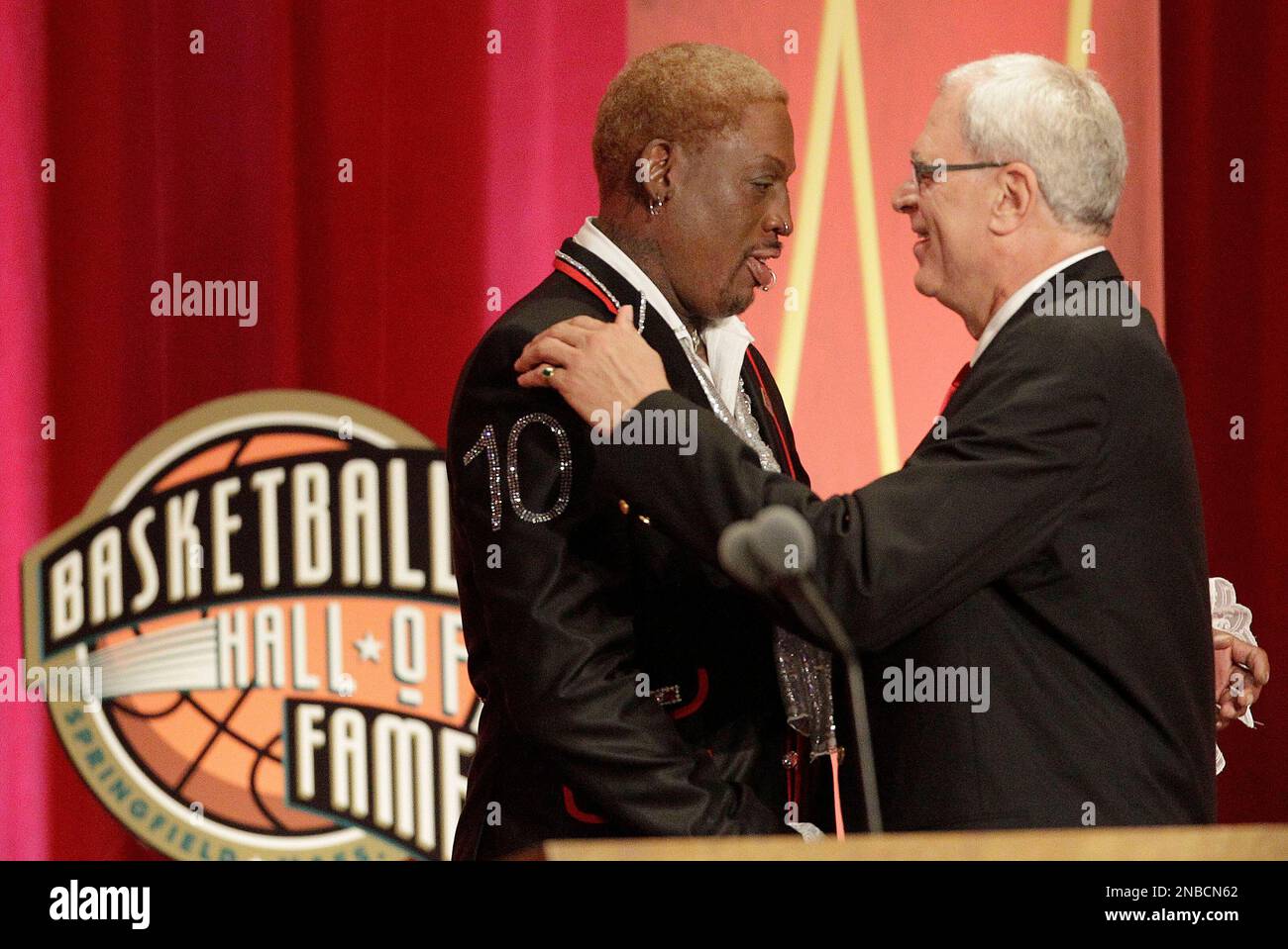 Dennis Rodman, left, is embraced by coach Phil Jackson at Rodman's ...