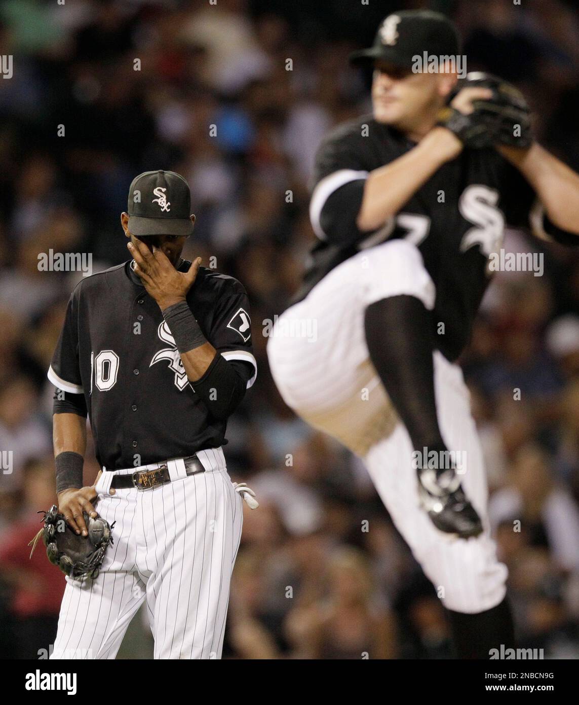 Chicago White Sox shortstop Alexei Ramirez, left, wipes his face while ...