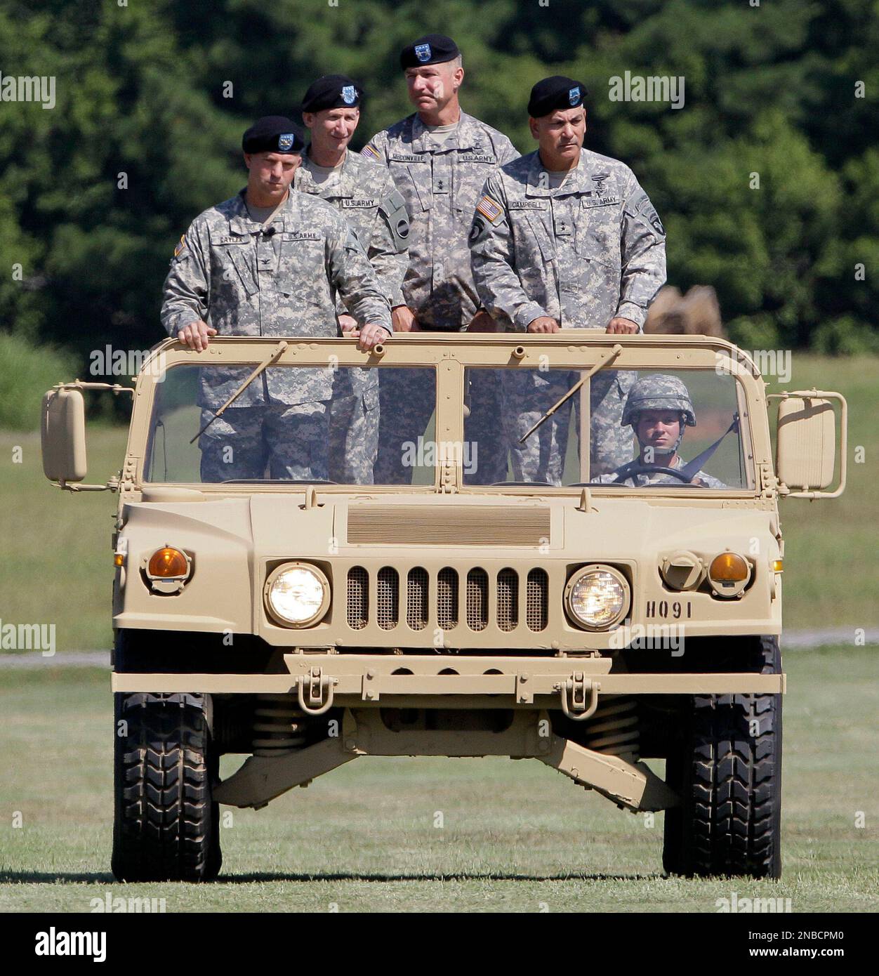 Maj. Gen. John F. Campbell, standing at right, the outgoing commander ...