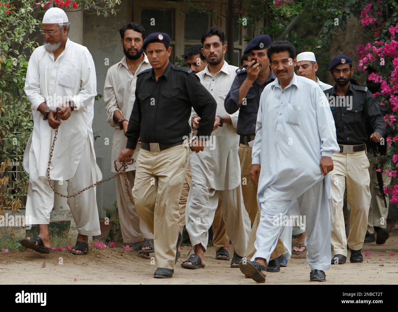 Pakistani police officers escort troops of para military force to an ...