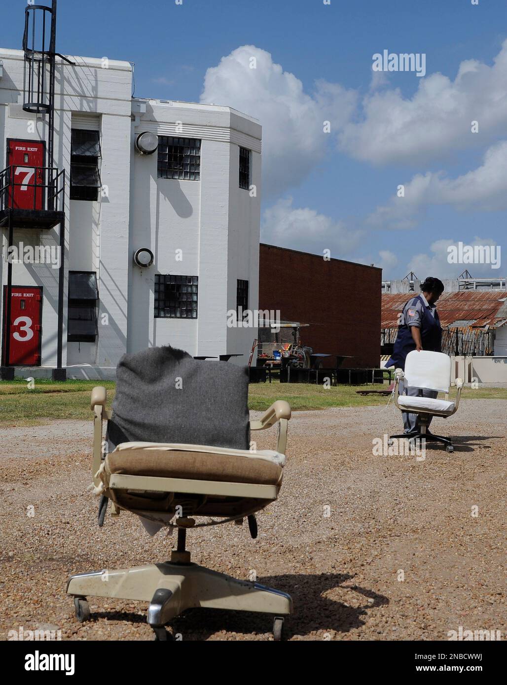 A desk chair sits outside a prison building as a correctional officer ...