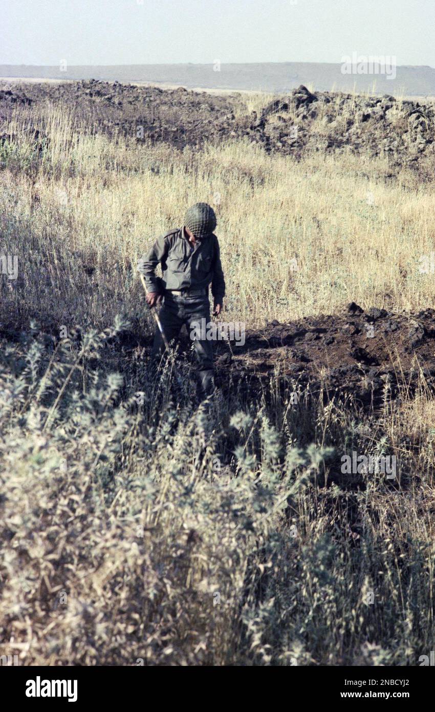 Syrian soldiers search for mines in June 1974 buried in the ground ...
