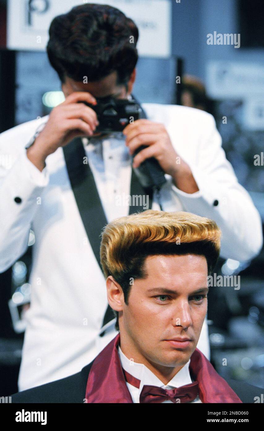 A competing hair model takes a picture of another competitor's hair ...